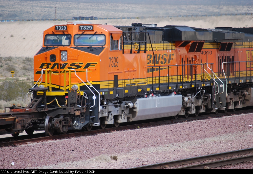 Close up of a Very Clean BNSF 7329 2d unit behind BNSF 4010 pulling a mty spine car consist West.